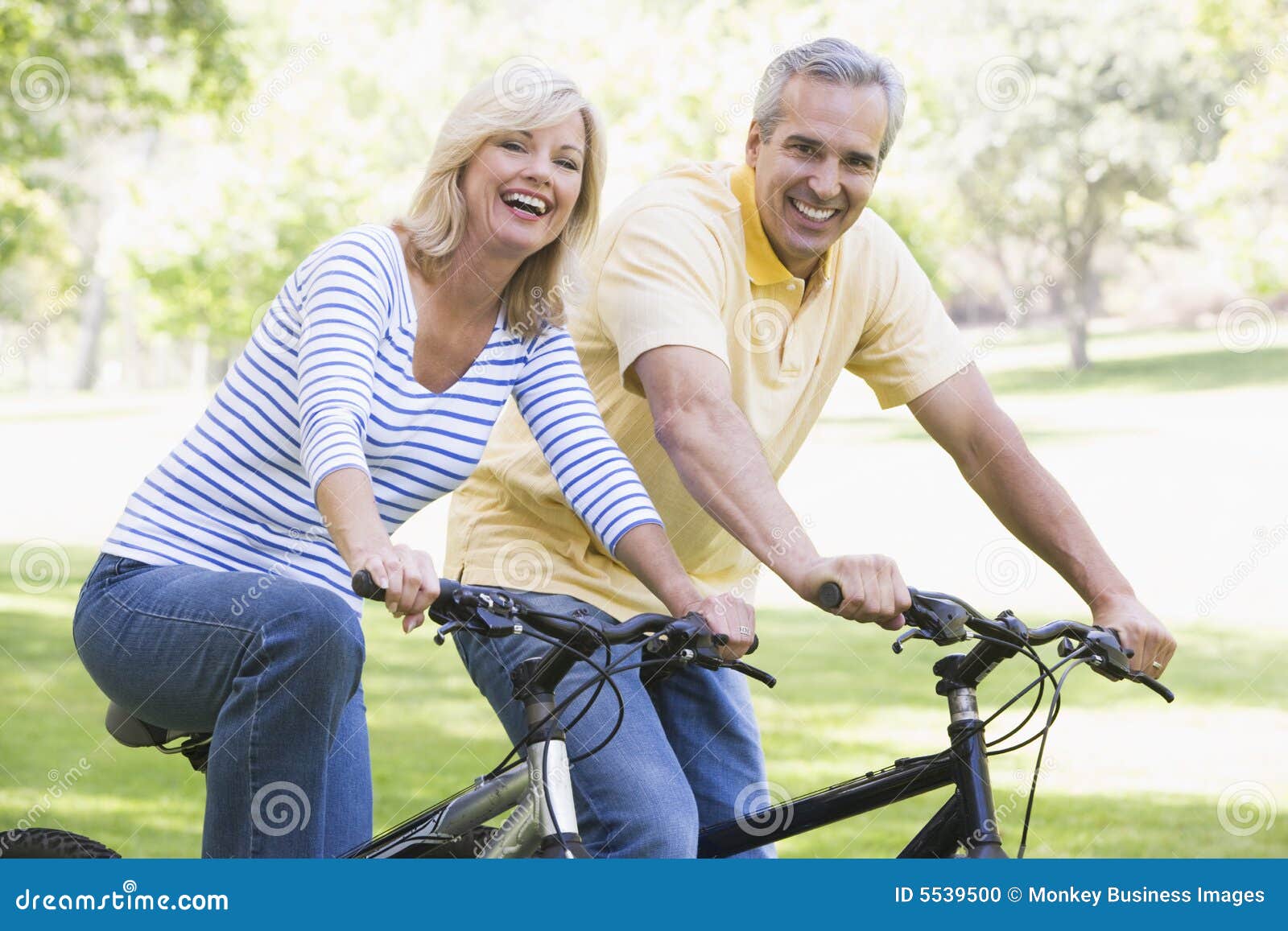 Couple on Bikes Outdoors Smiling Stock Photo - Image of cycling, middle ...