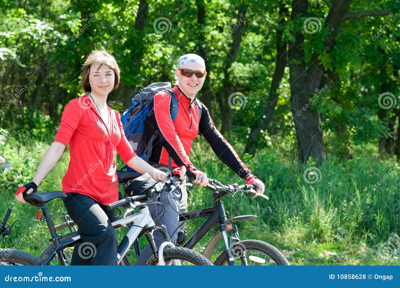 Couple biking stock photo. Image of grass, leisure, bicycle - 10858628