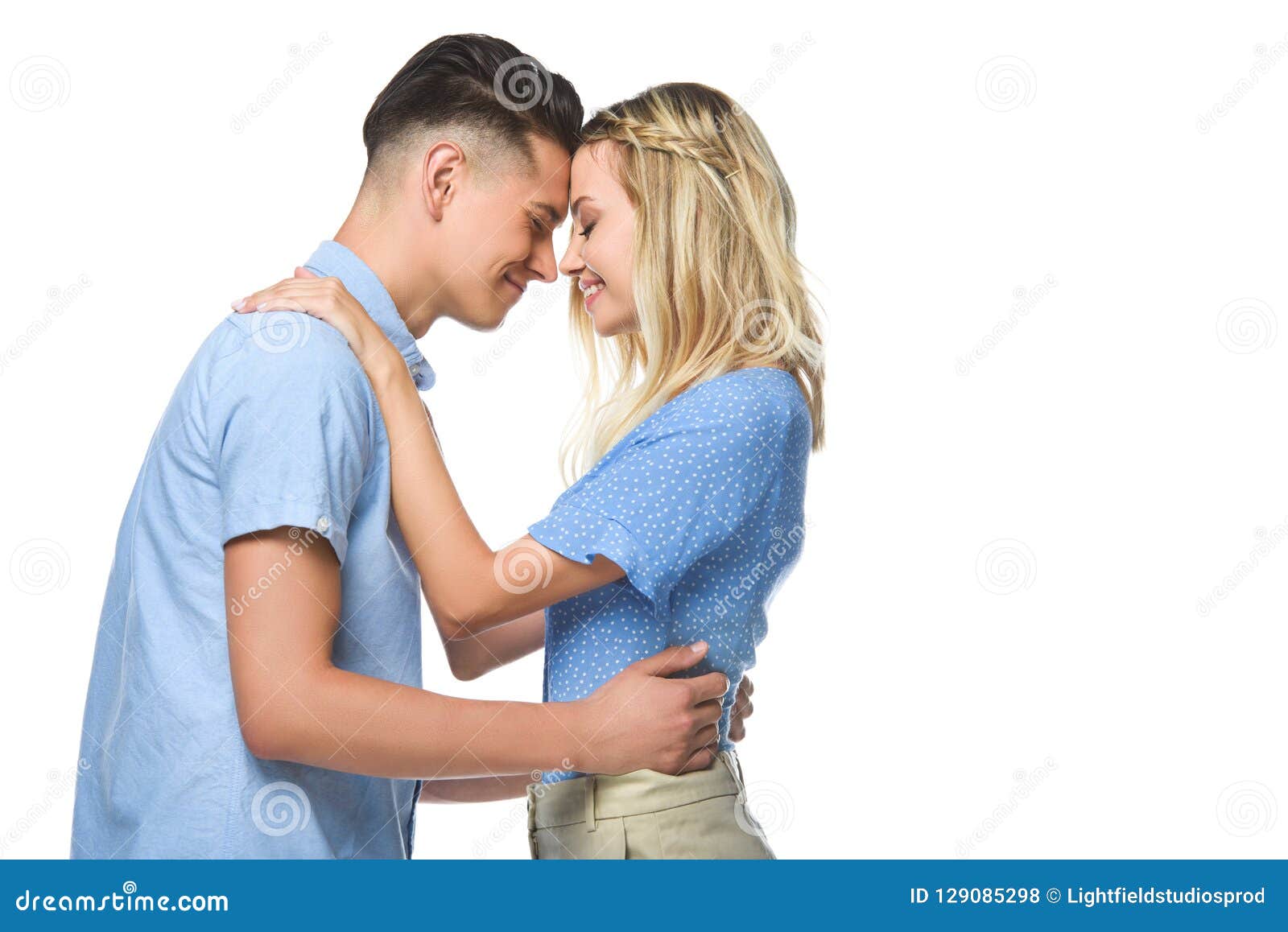 Couple in Blue Shirts Hugging and Touching with Foreheads Stock Photo ...