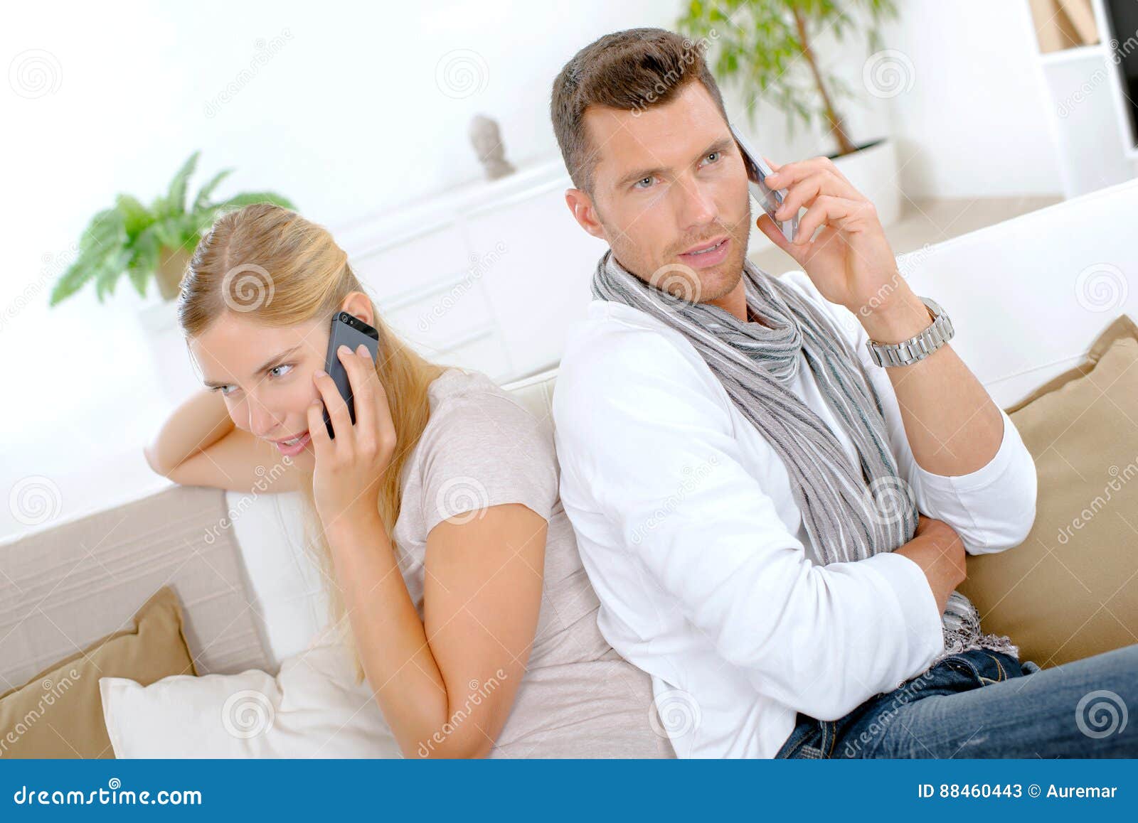 Couple Both Using Their Phones on Sofa Stock Image - Image of ...