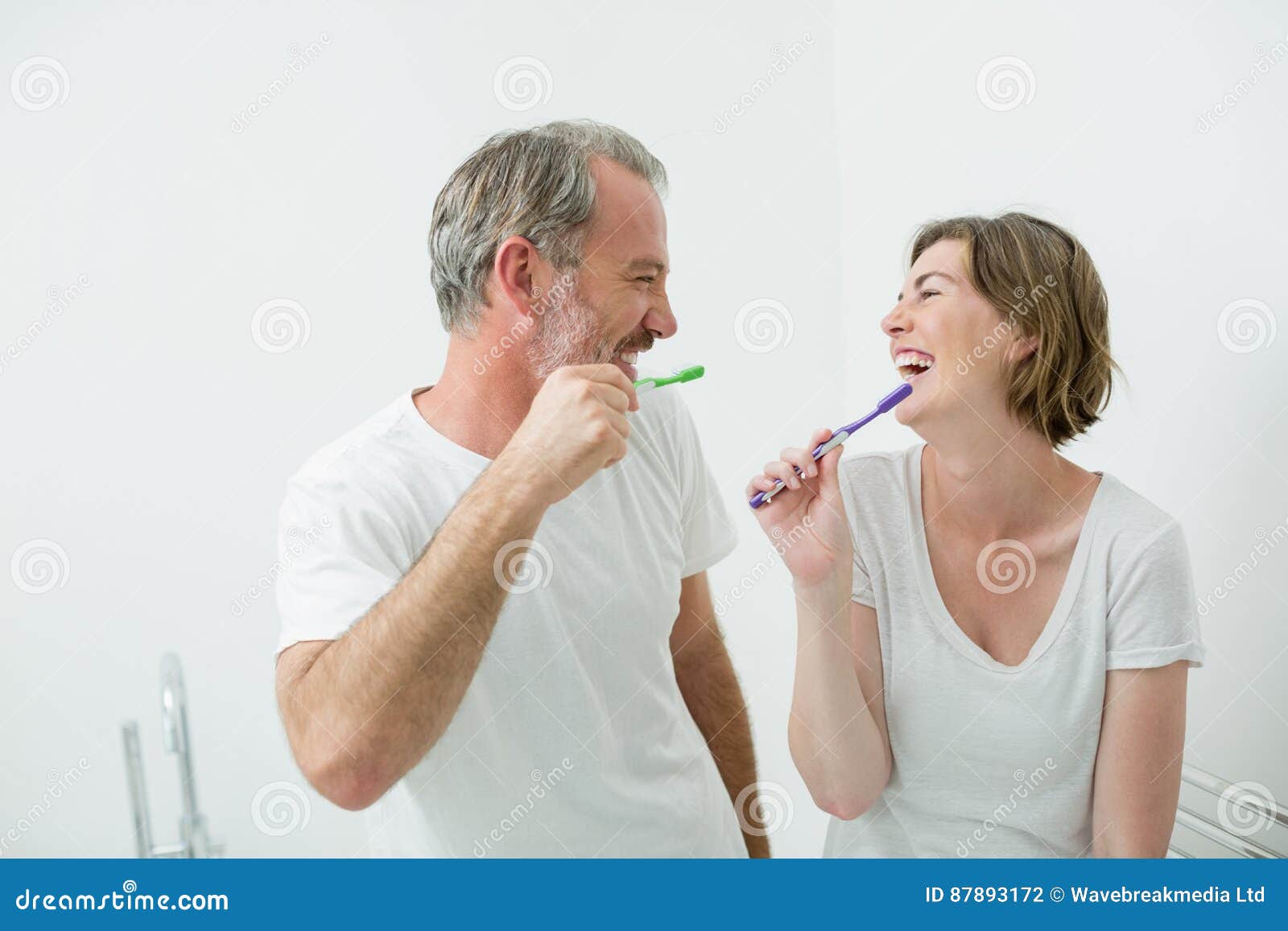 Couple Brushing Their Teeth with Toothbrush at Home Stock Photo - Image ...