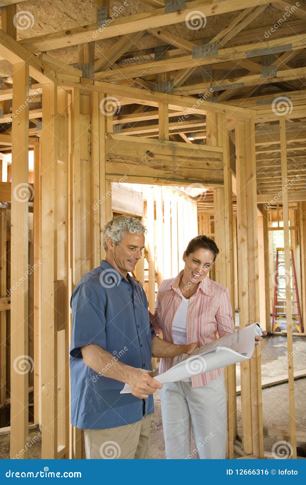 Couple Building Home stock photo. Image of framed, blueprints - 12666316