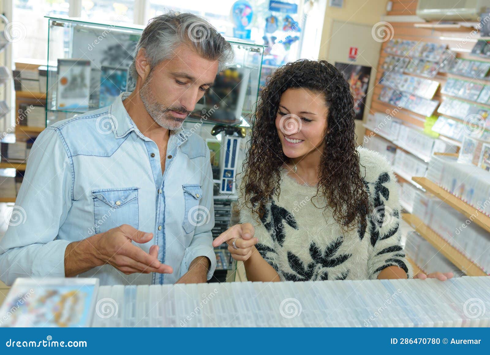 Couple buying movie disk stock photo. Image of shop - 286470780