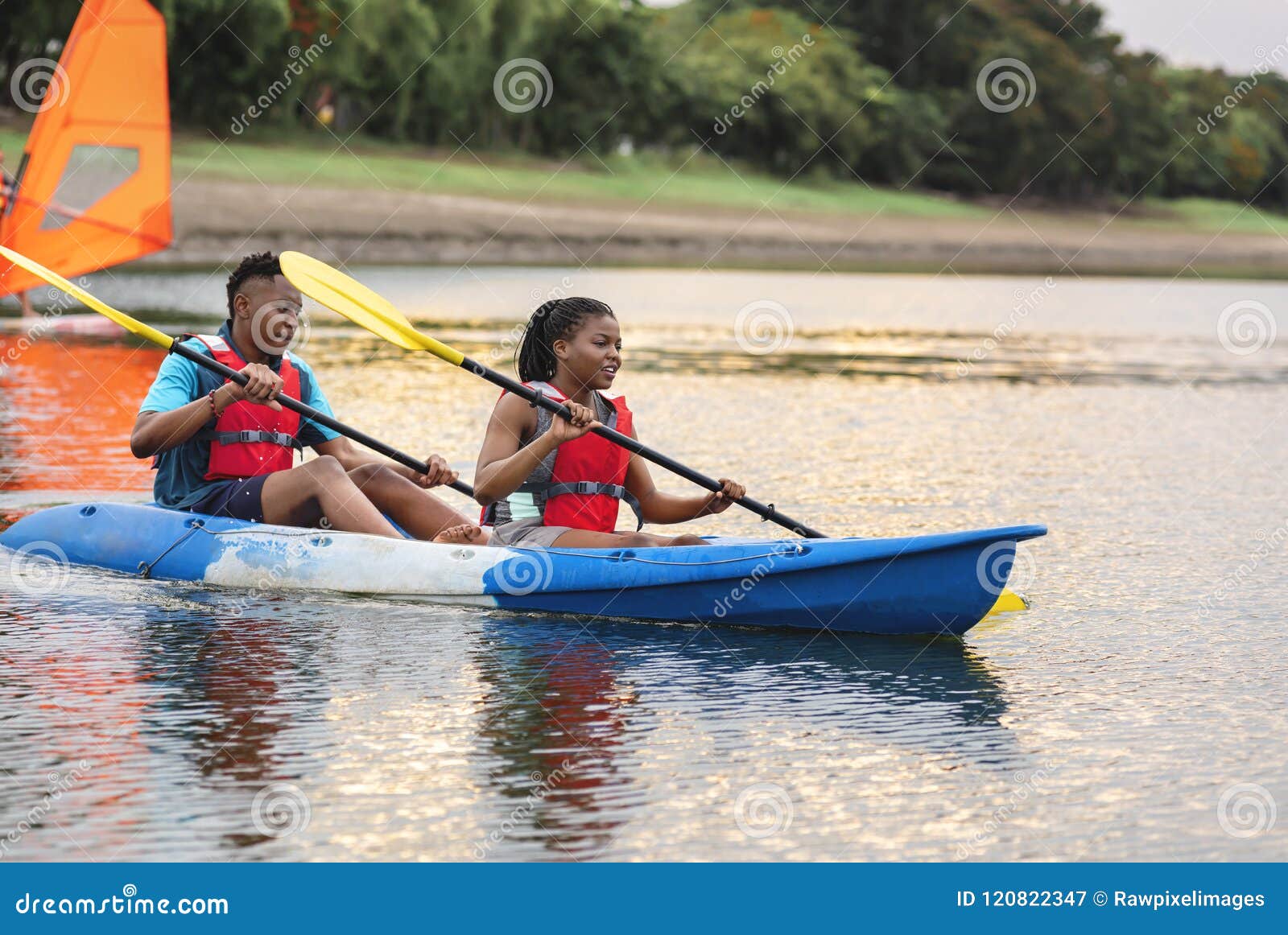 Couple canoeing in a lake stock image. Image of canoeing - 120822347