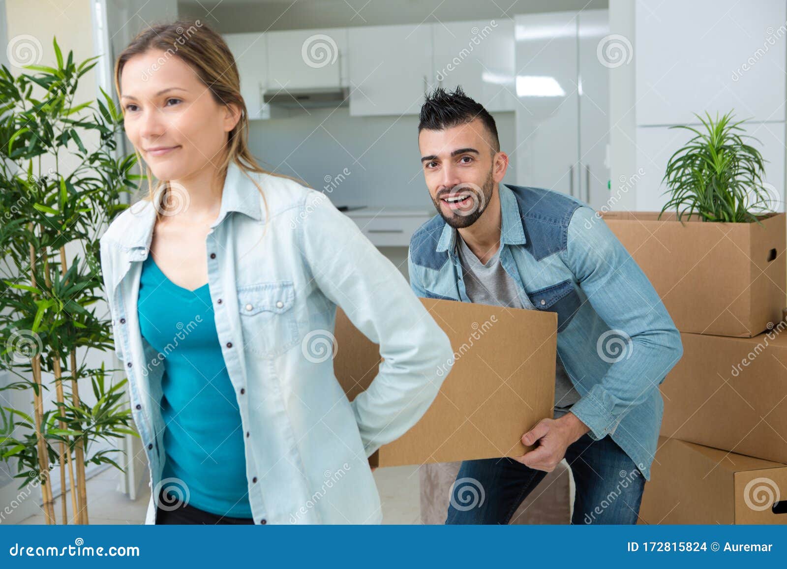 Couple carrying heavy box stock photo. Image of relocate - 172815824