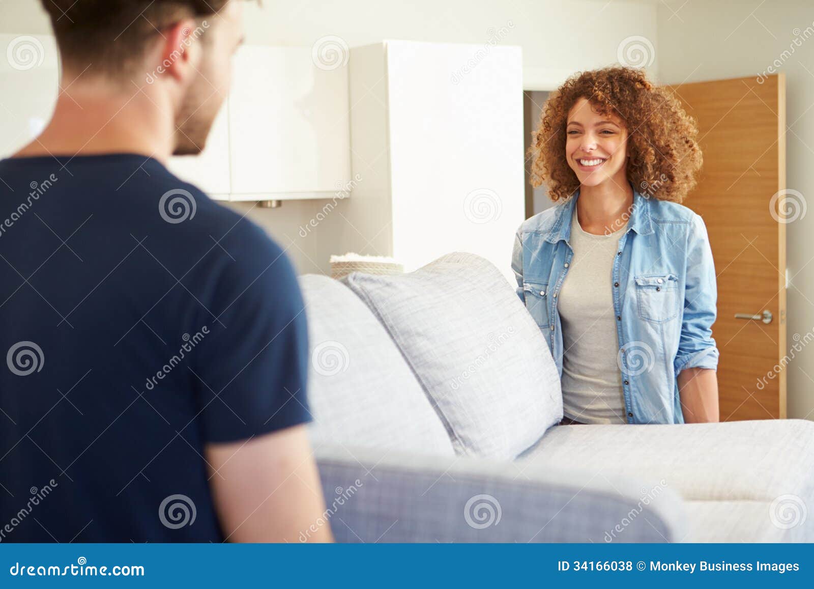 Couple Carrying Sofa As they Move into New Home Stock Photo - Image of ...