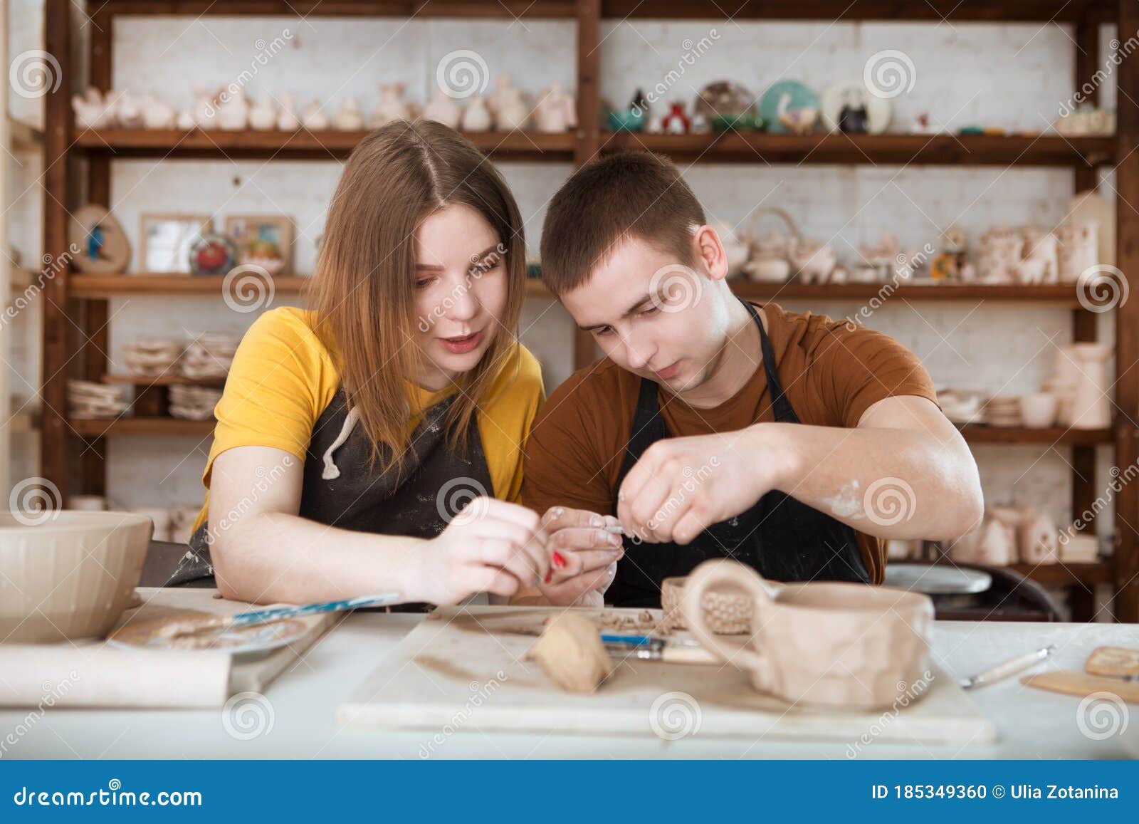 Couple in Casual Clothes and Aprons Making Ceramic Pot on Pottery at ...