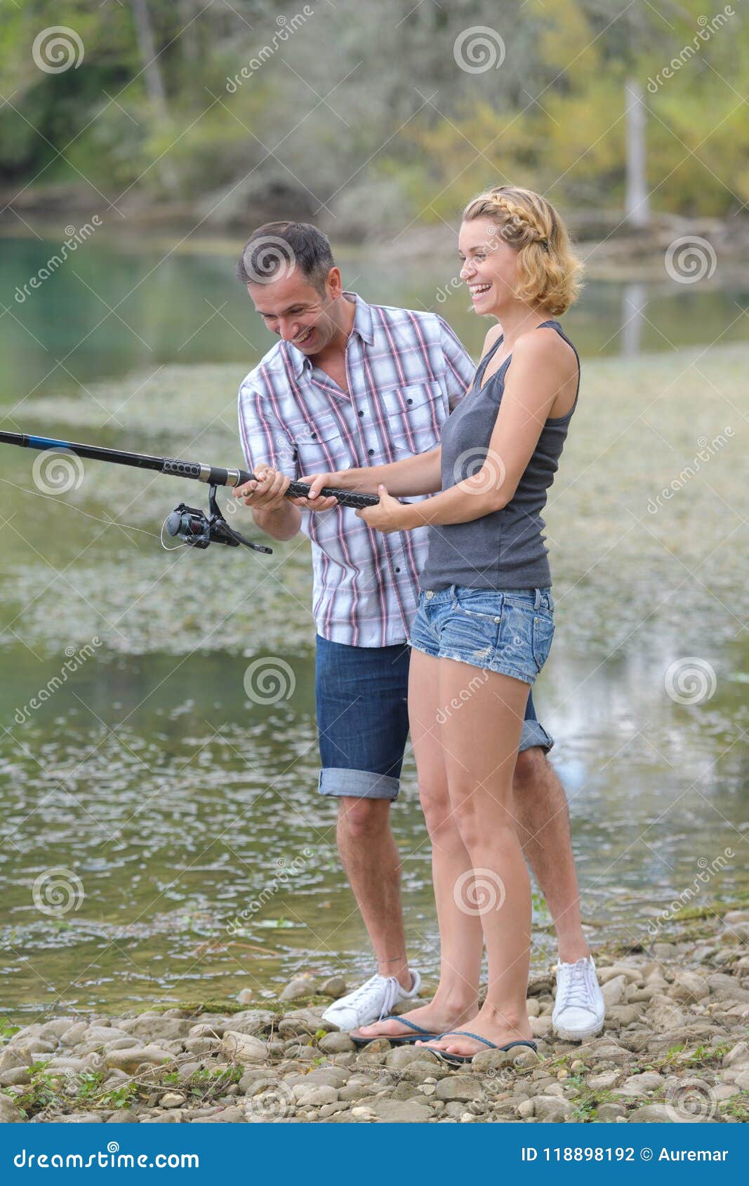 Couple catching a fish stock photo. Image of park, nature - 118898192