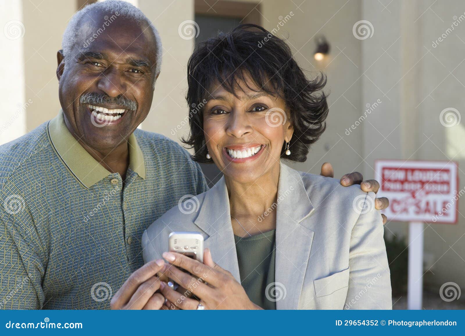 Couple with Cell Phone in Front of New House Stock Photo - Image of ...