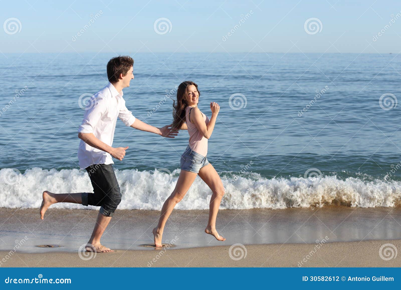 Teen Couple Chasing Beach Stock Photos - Free & Royalty-Free Stock ...