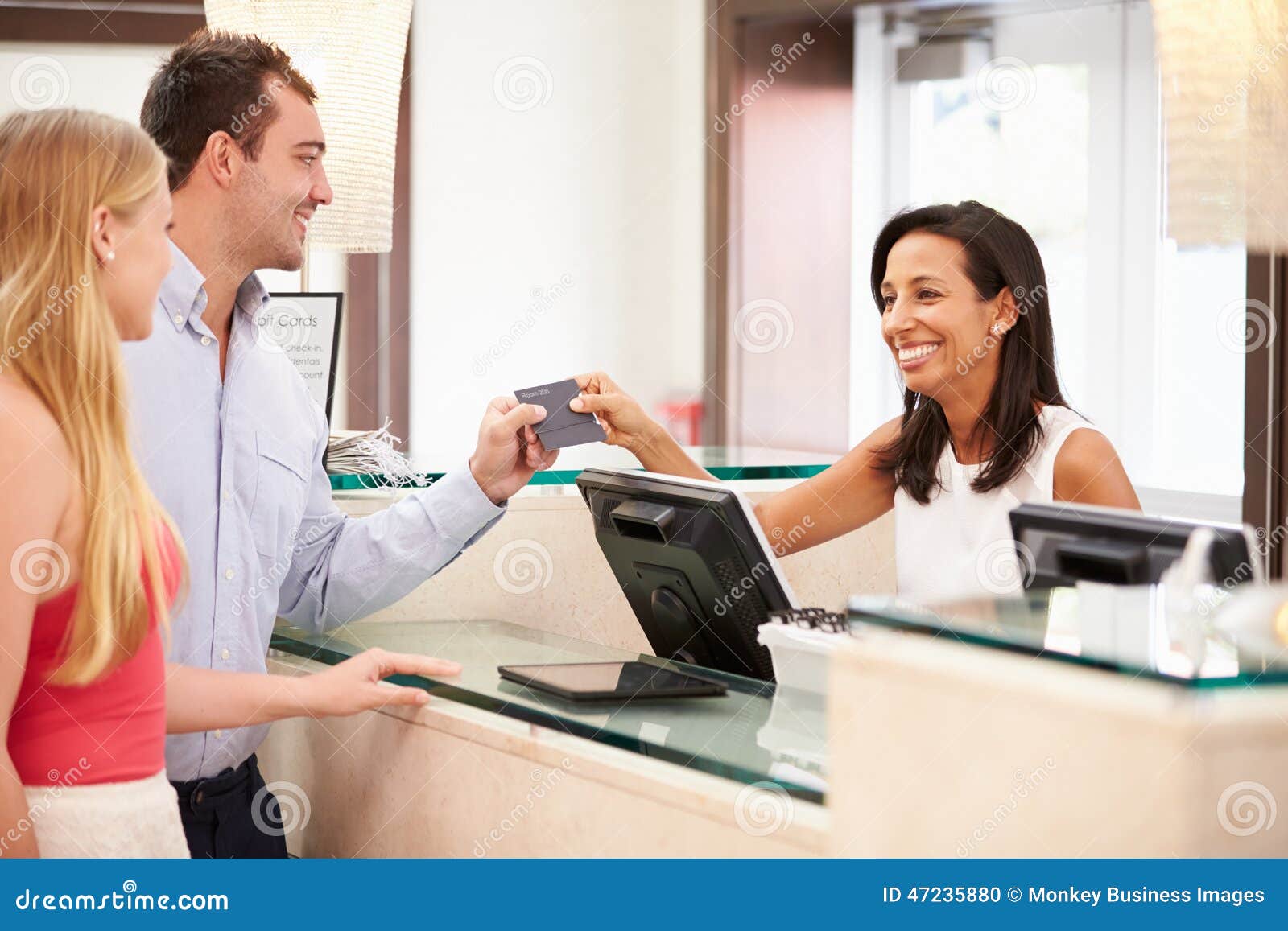 Couple Checking in at Hotel Reception Stock Photo - Image of women ...