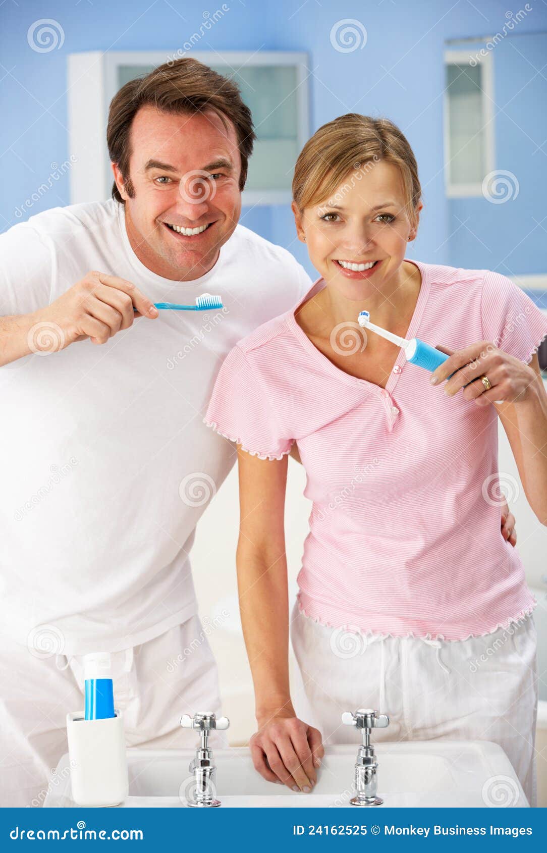 Couple Cleaning Teeth Together in Bathroom Stock Image - Image of ...
