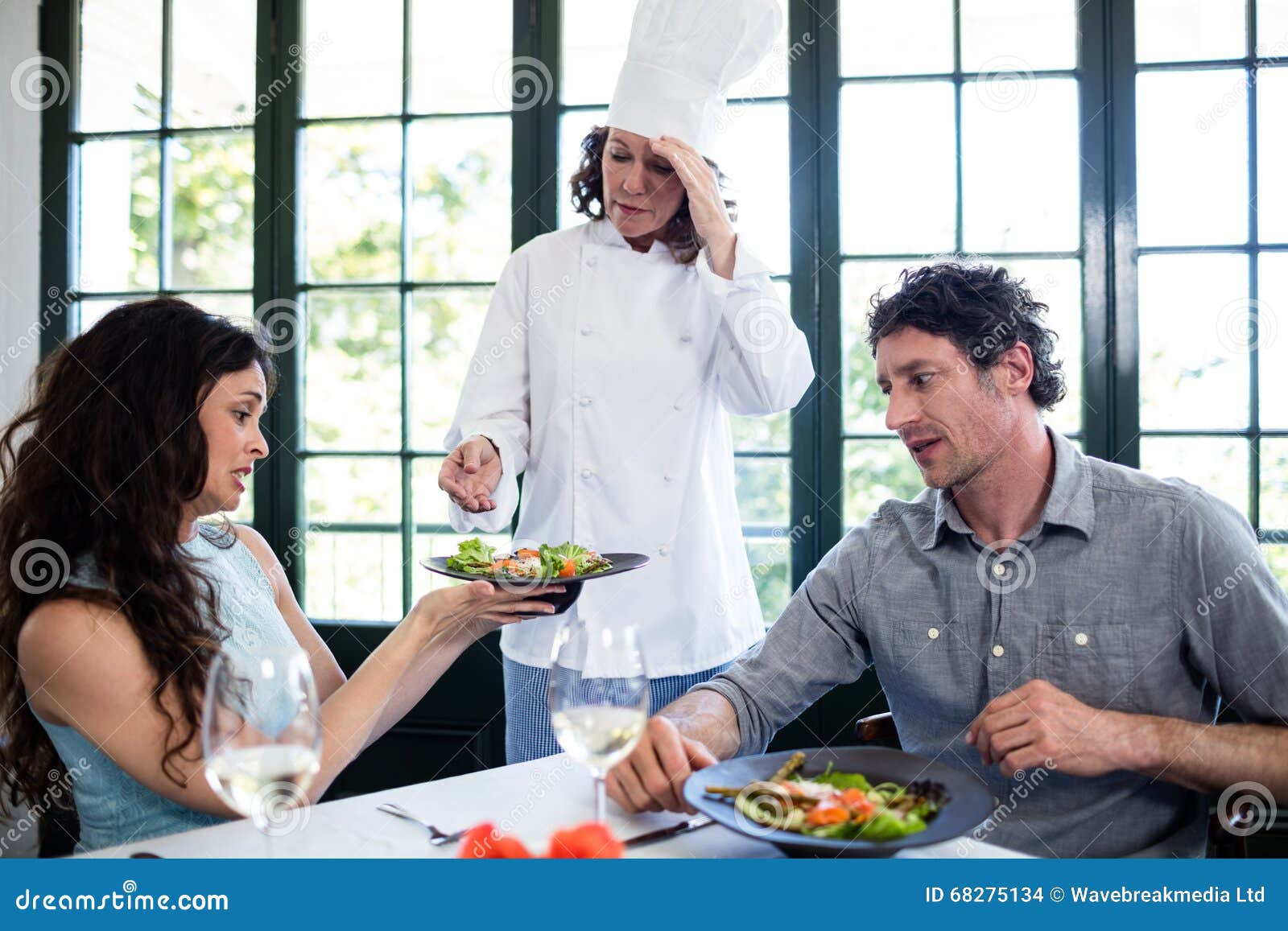 Couple Complaining about the Food To Chef Stock Photo - Image of ...