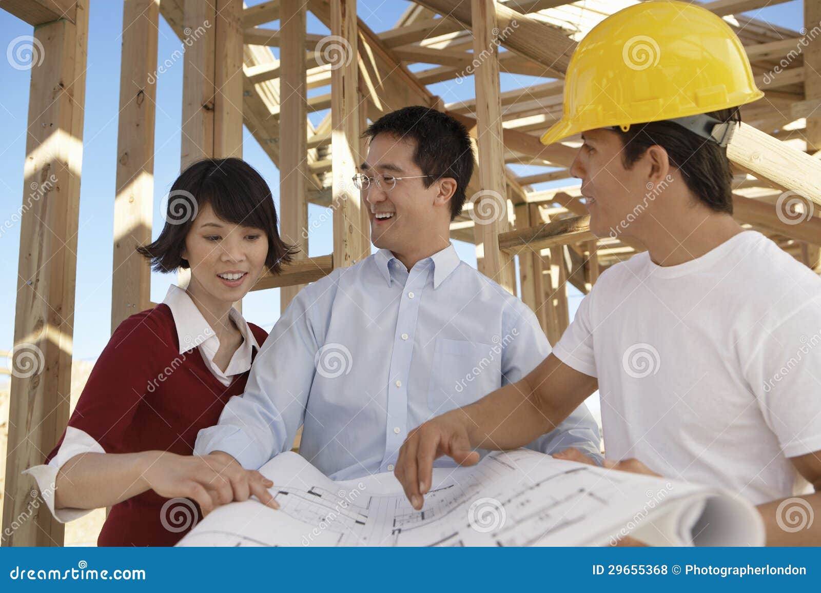 Couple with Contractor at Construction Site Stock Photo - Image of ...
