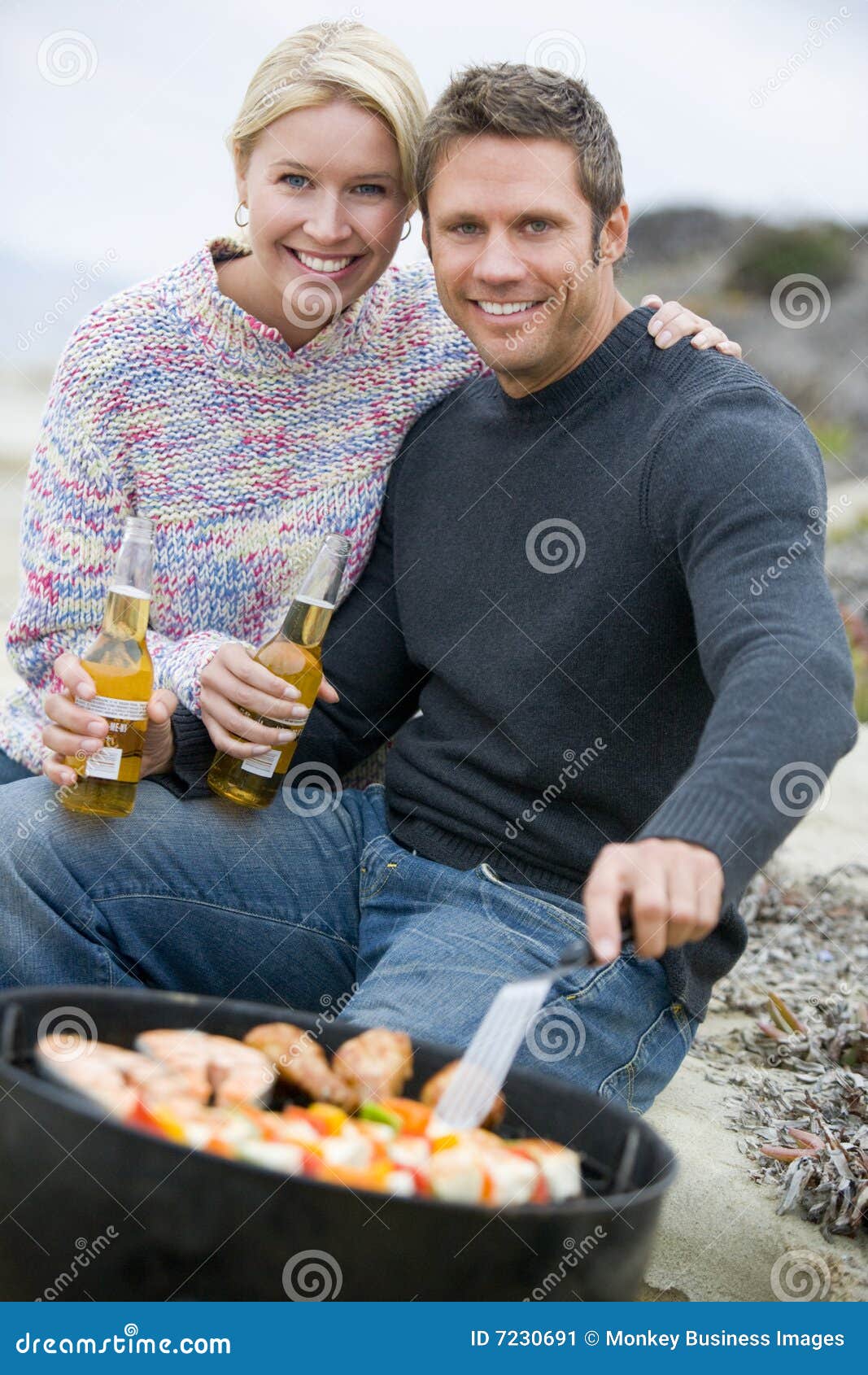 Couple Cooking Barbeque on a Beach Stock Image - Image of selective ...