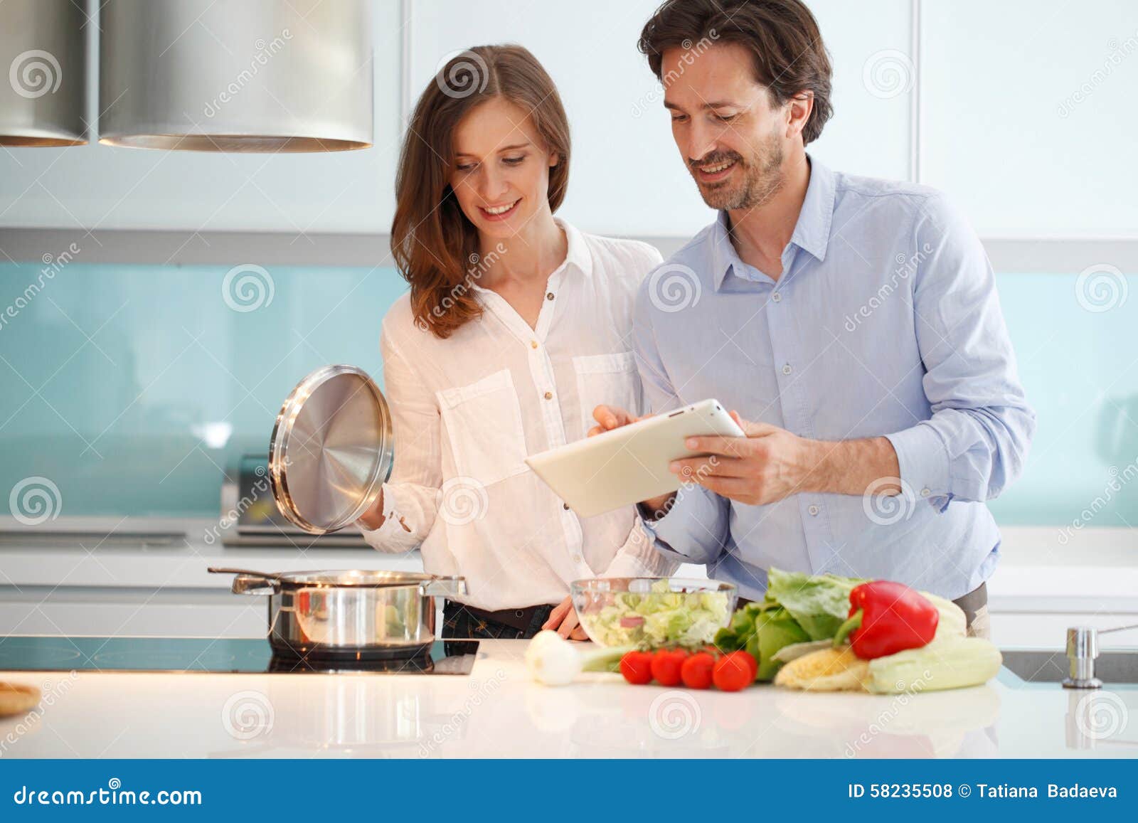 Couple cooking dinner stock photo. Image of interior - 58235508