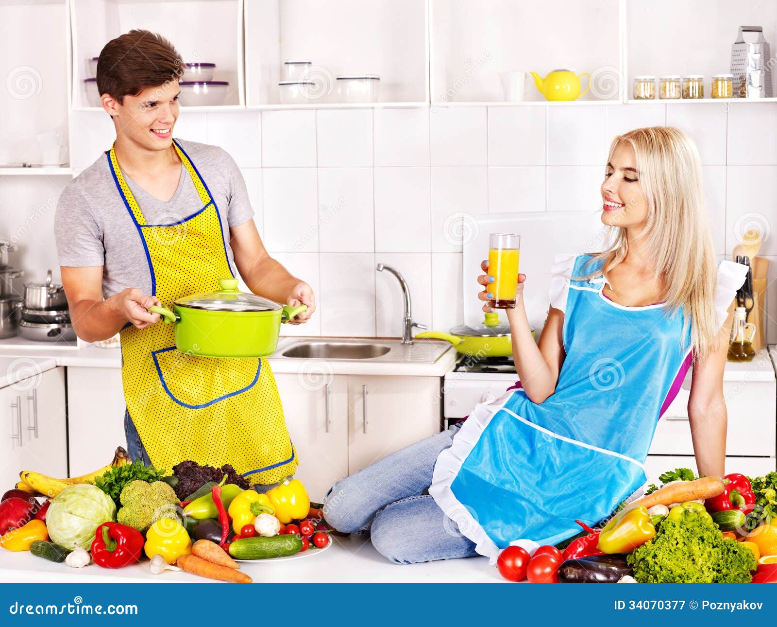 Couple cooking at kitchen. stock image. Image of kitchen - 34070377