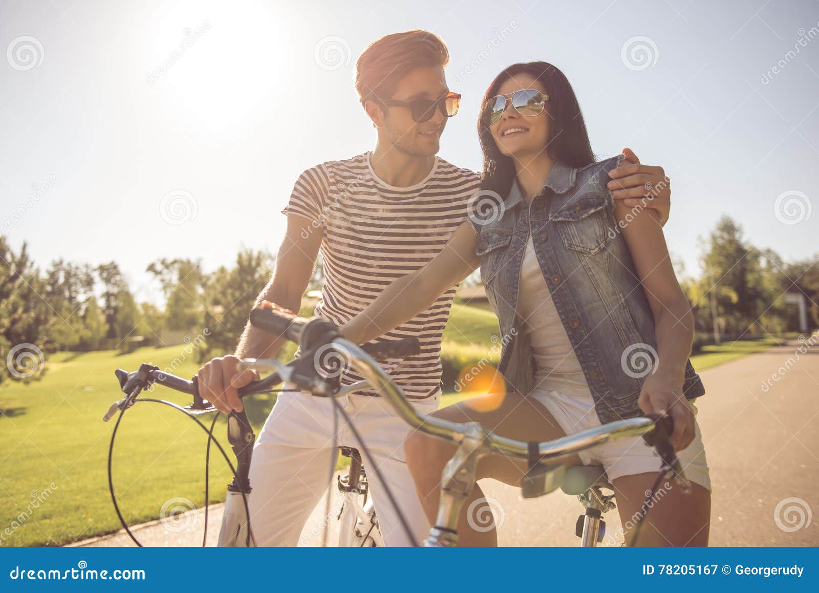 Couple cycling in park stock image. Image of glasses - 78205167