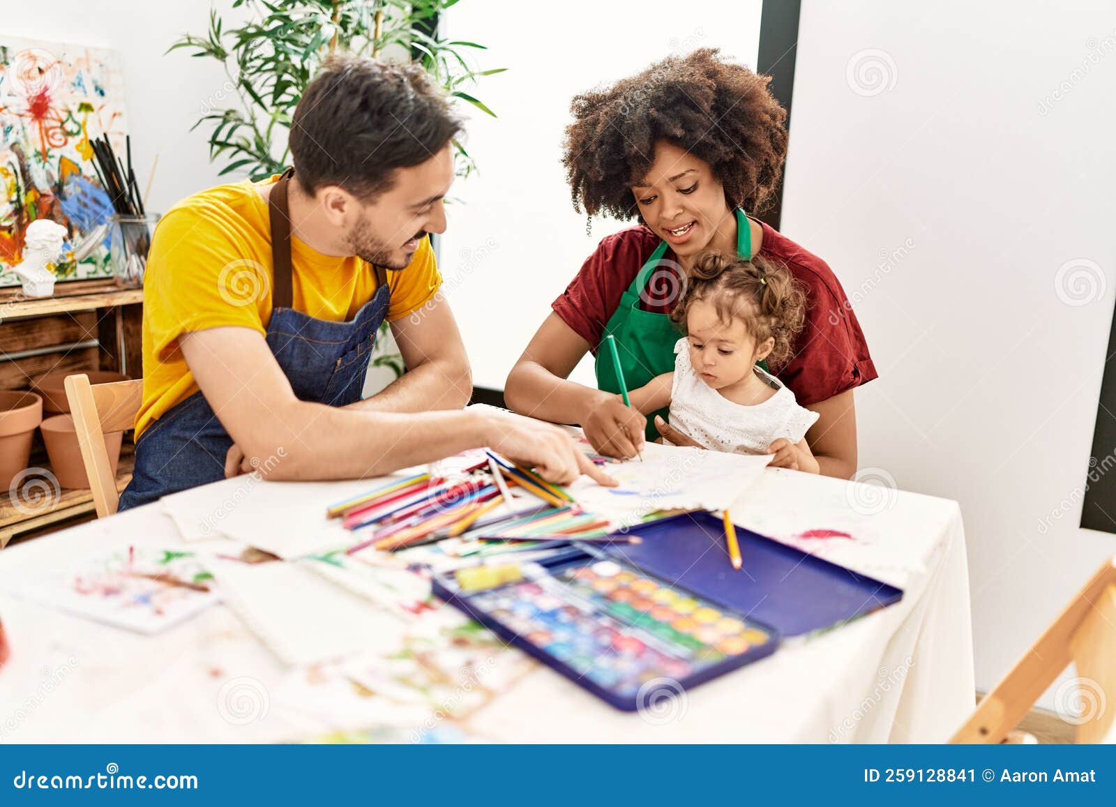 Couple and Daughter Smiling Confident Drawing at Art Studio Stock Image ...