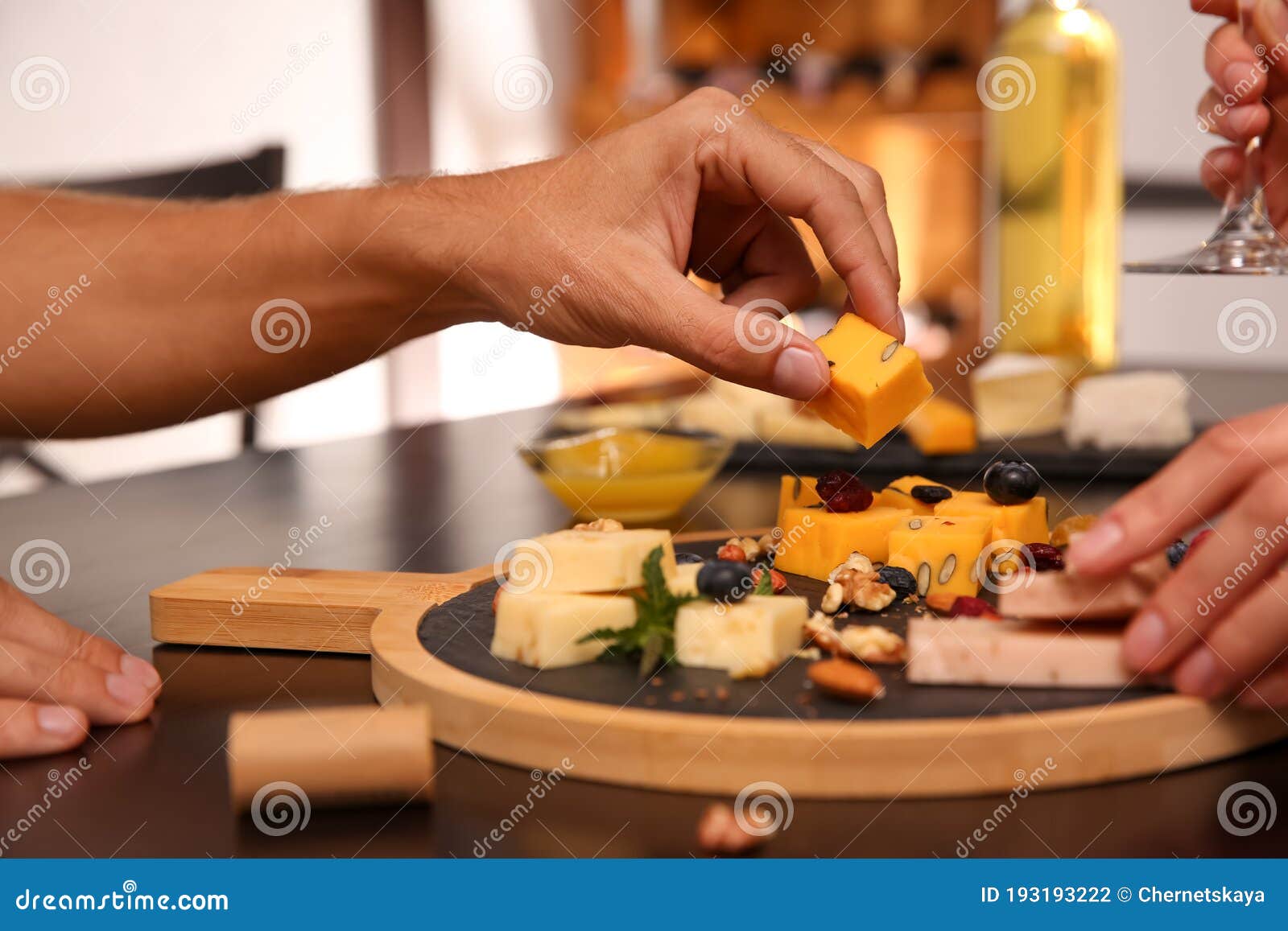 Couple with Different Types of Cheeses at Table Indoors, Closeup Stock ...