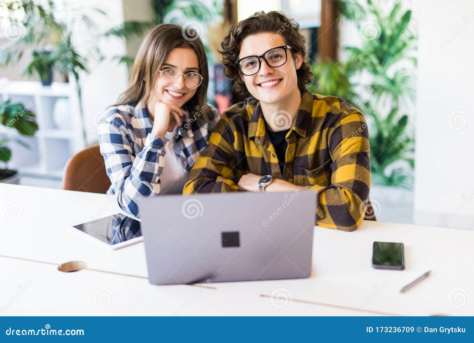 Young Couple Discussing New Project on the Laptop. Teamwork Concepts ...