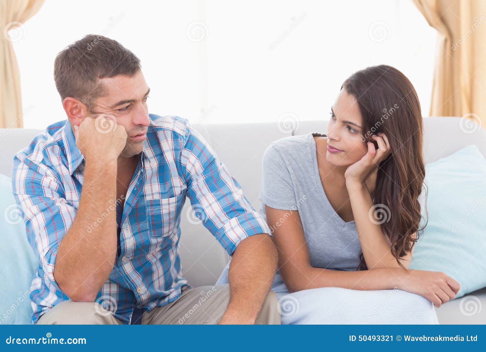 Couple discussing on sofa stock image. Image of quarter - 50493321