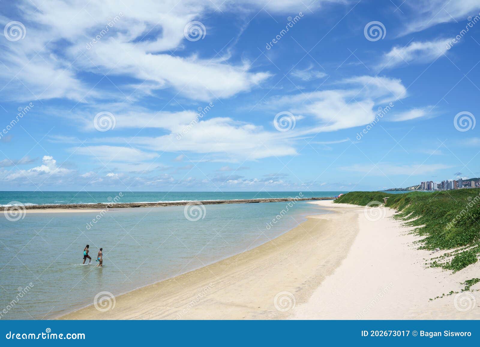 A Couple in Distance on the Beach by the City Stock Image - Image of ...