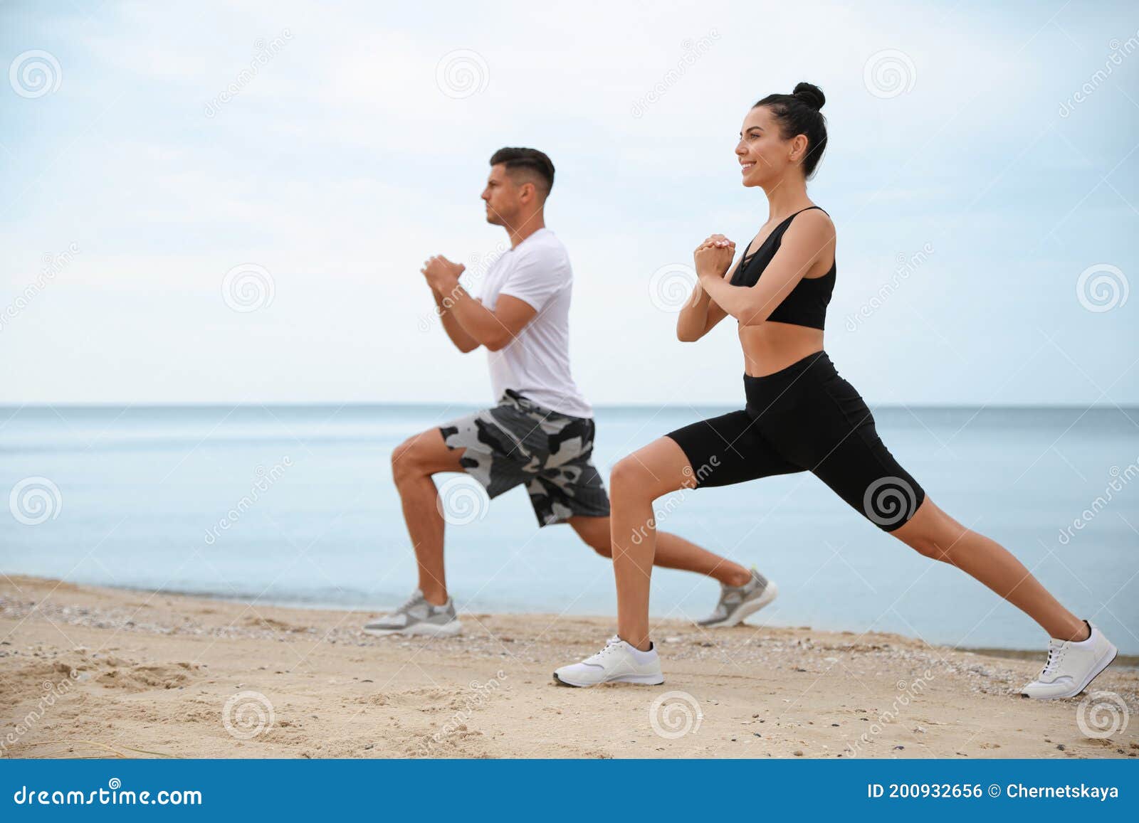 Couple Doing Exercise Together on Beach. Body Training Stock Photo ...