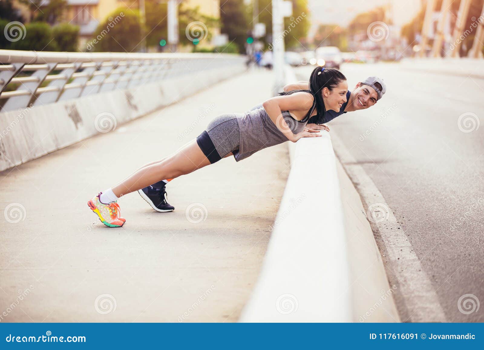 Couple Doing Push-ups Outdoors on the Bridge Stock Image - Image of ...