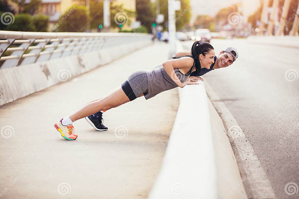 Couple Doing Push-ups Outdoors on the Bridge Stock Image - Image of ...