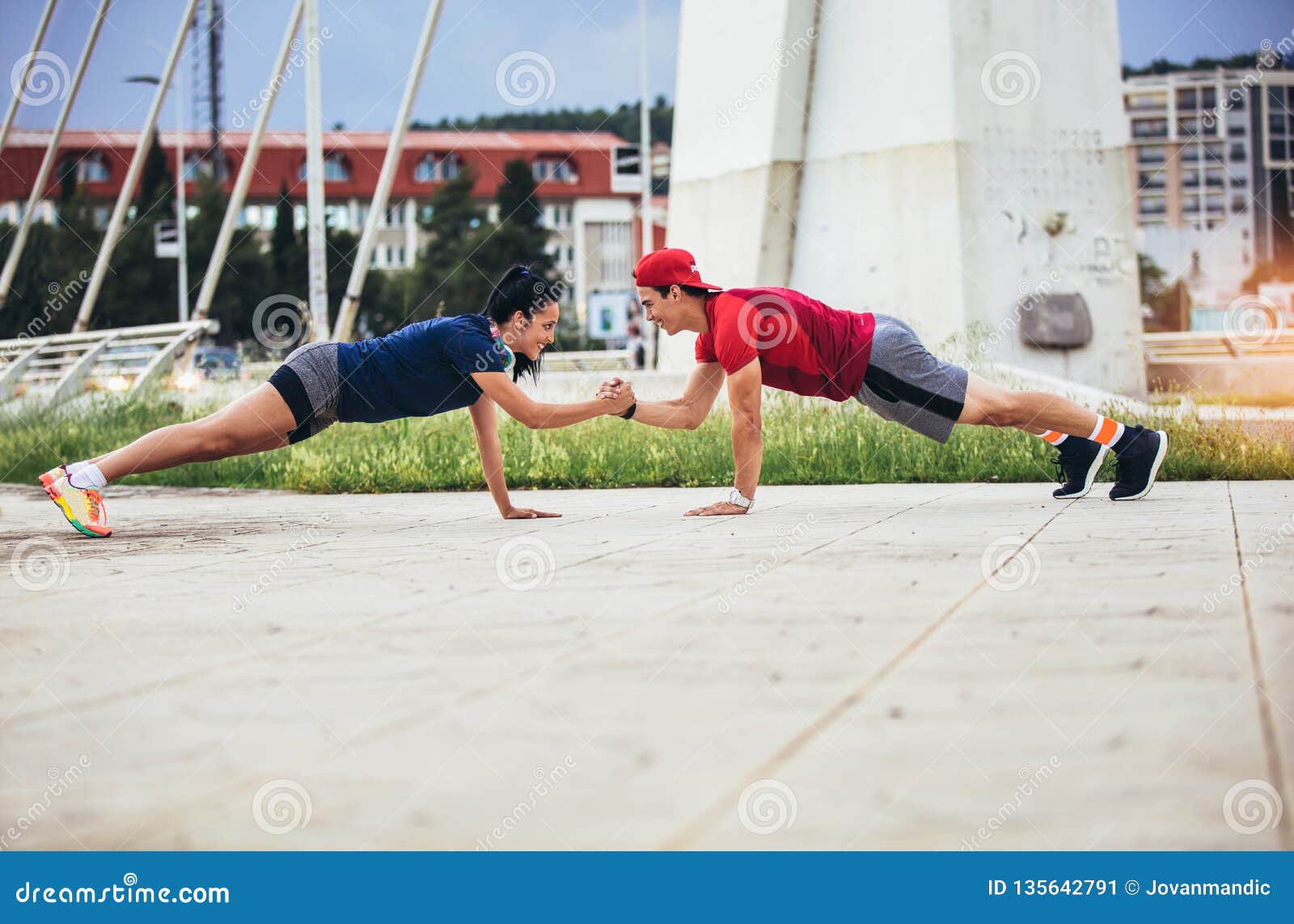 Couple Doing Push-ups Outdoors on the Bridge Stock Image - Image of ...