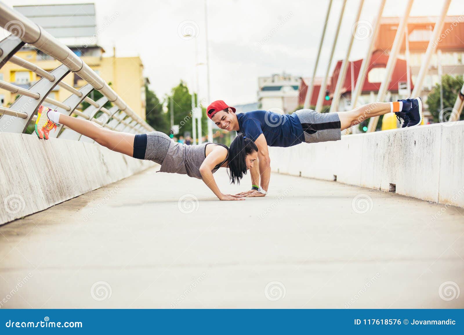 Couple Doing Push-ups Outdoors on the Bridge Stock Photo - Image of ...