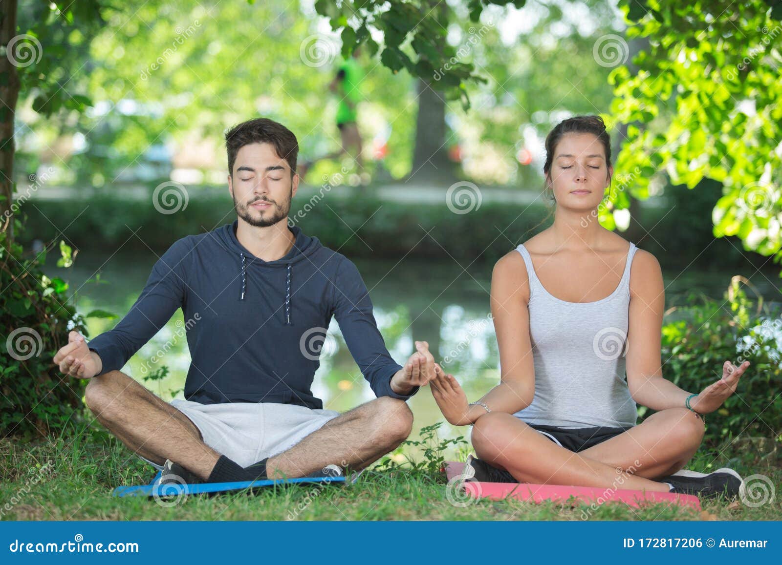 Couple doing yoga in park stock photo. Image of jetty - 172817206