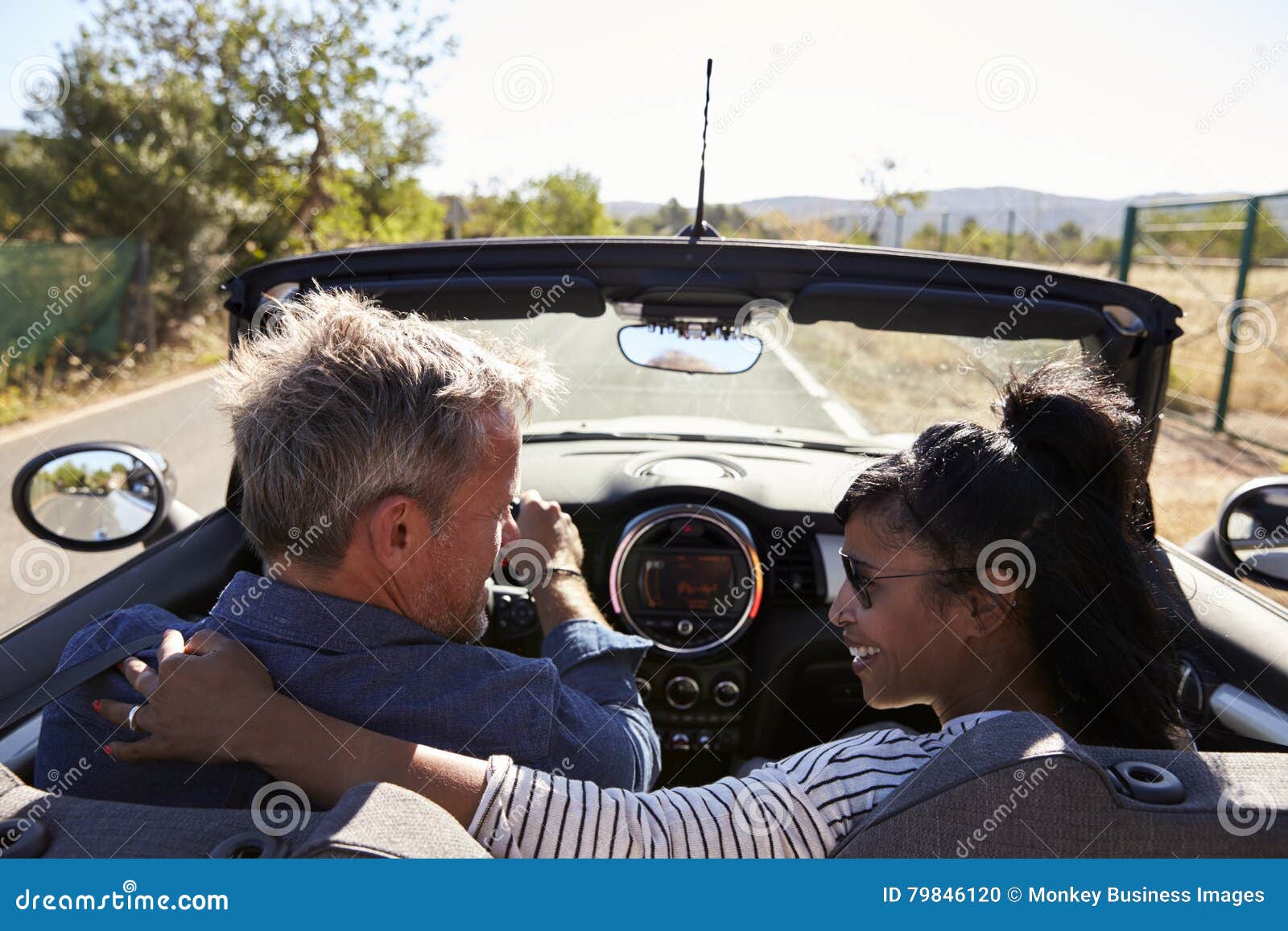 Couple Driving in Open Top Car Look at Each Other, Back View Stock ...