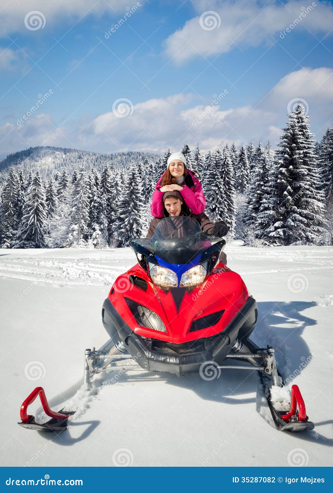 Couple driving snowmobile stock photo. Image of leisure - 35287082