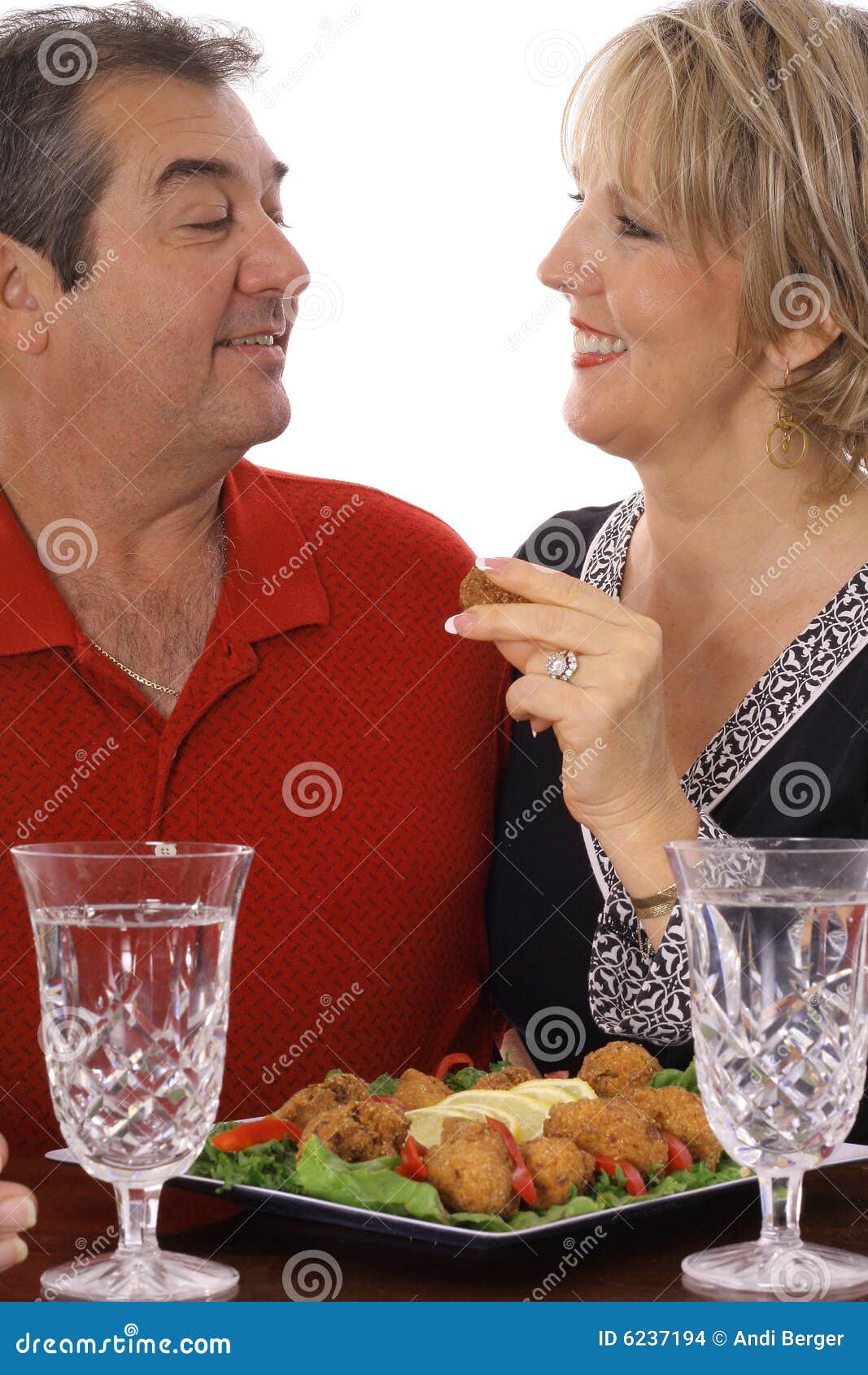 Couple eating appetizers stock photo. Image of happiness - 6237194