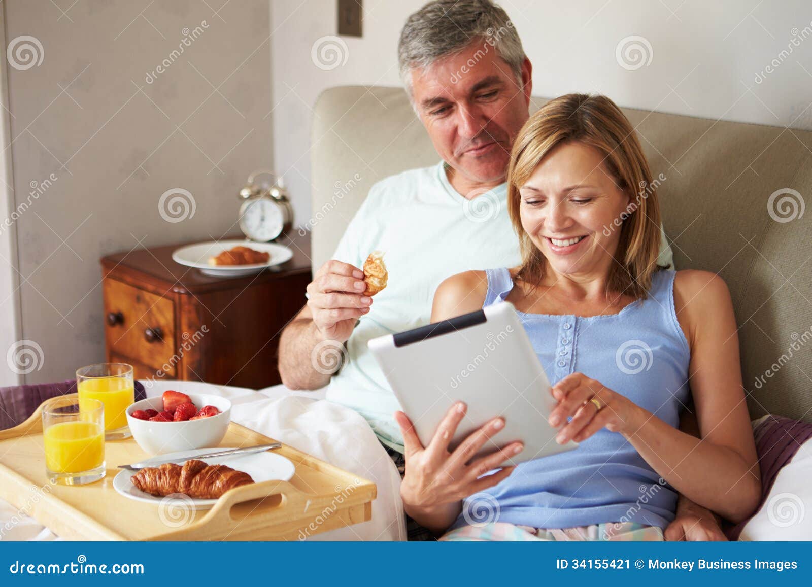Couple Eating Breakfast in Bed with Digital Tablet Stock Image - Image ...