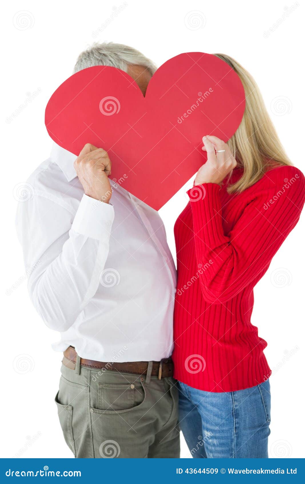 Couple Embracing and Holding Heart Over Faces Stock Image - Image of ...