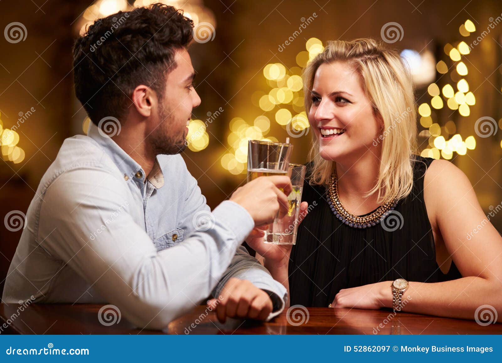 Couple Enjoying Evening Drinks in Bar Stock Image - Image of together ...