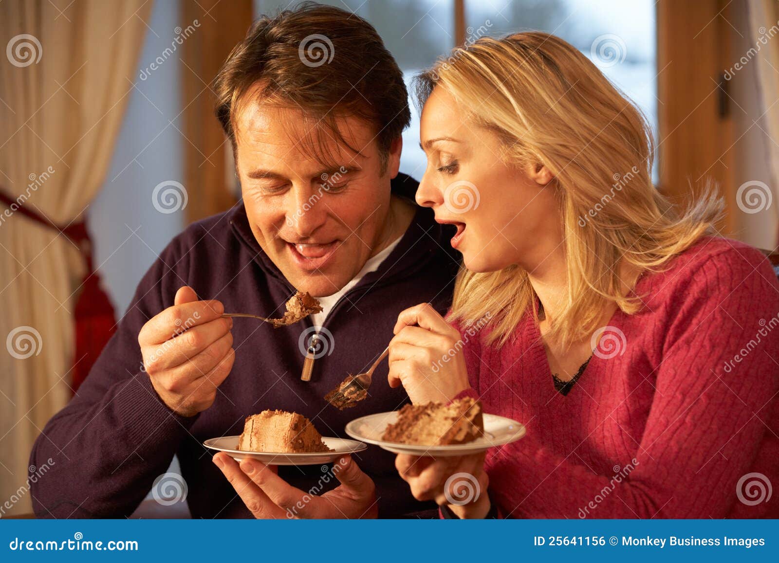 Couple Enjoying Slice of Cake Sitting on Sofa Stock Photo - Image of ...