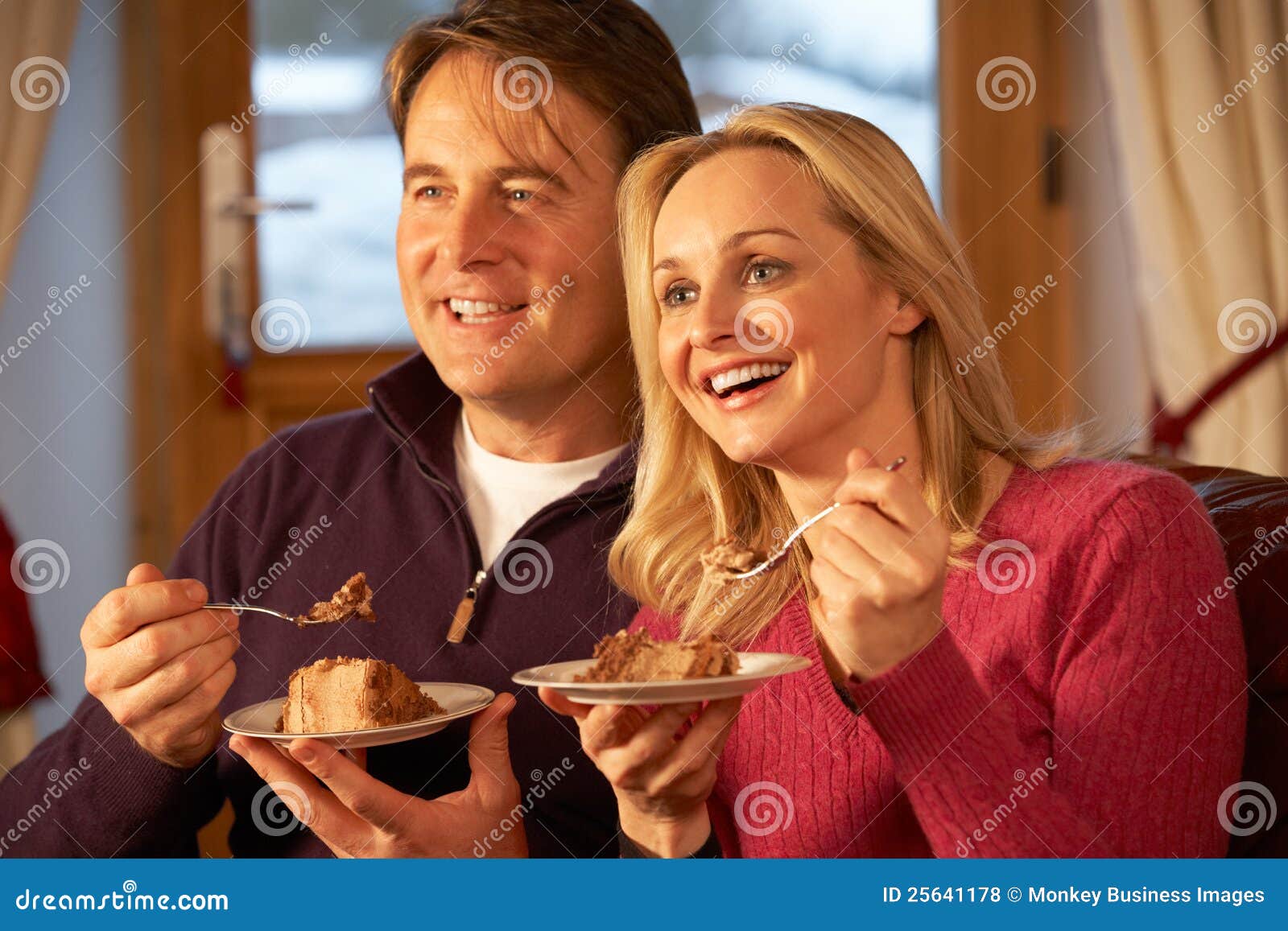 Couple Enjoying Slice of Cake Sitting on Sofa Stock Photo - Image of ...