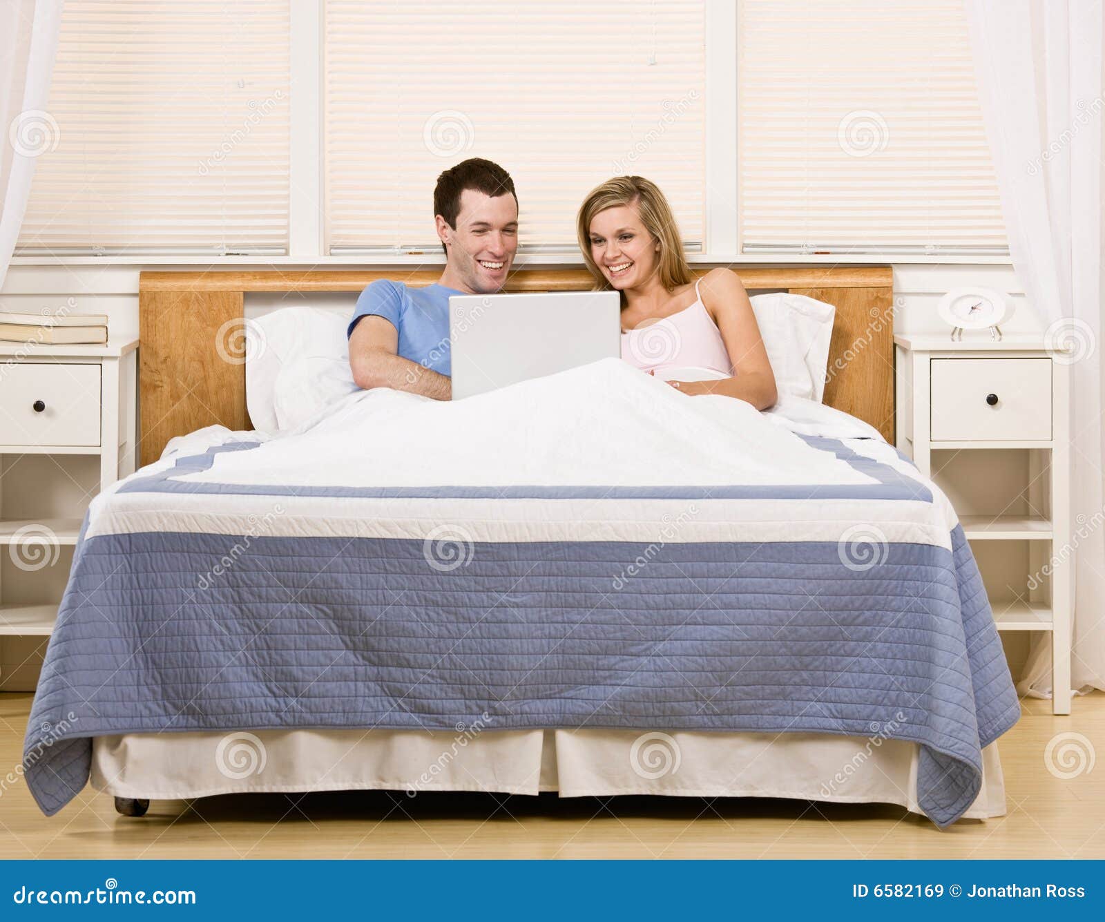 Couple Enjoying Using Laptop in Bed Stock Image - Image of hardy ...