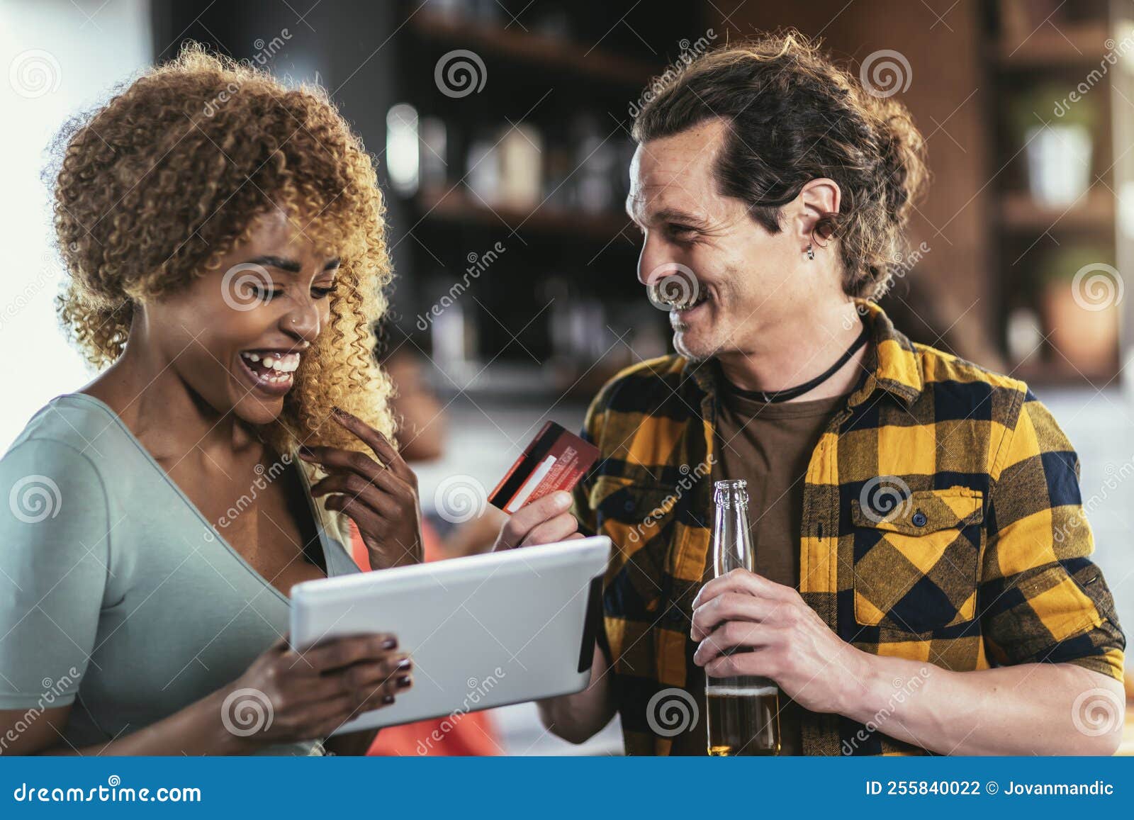 Couple Feeling Entertained while Using Credit Card for Online Payment ...