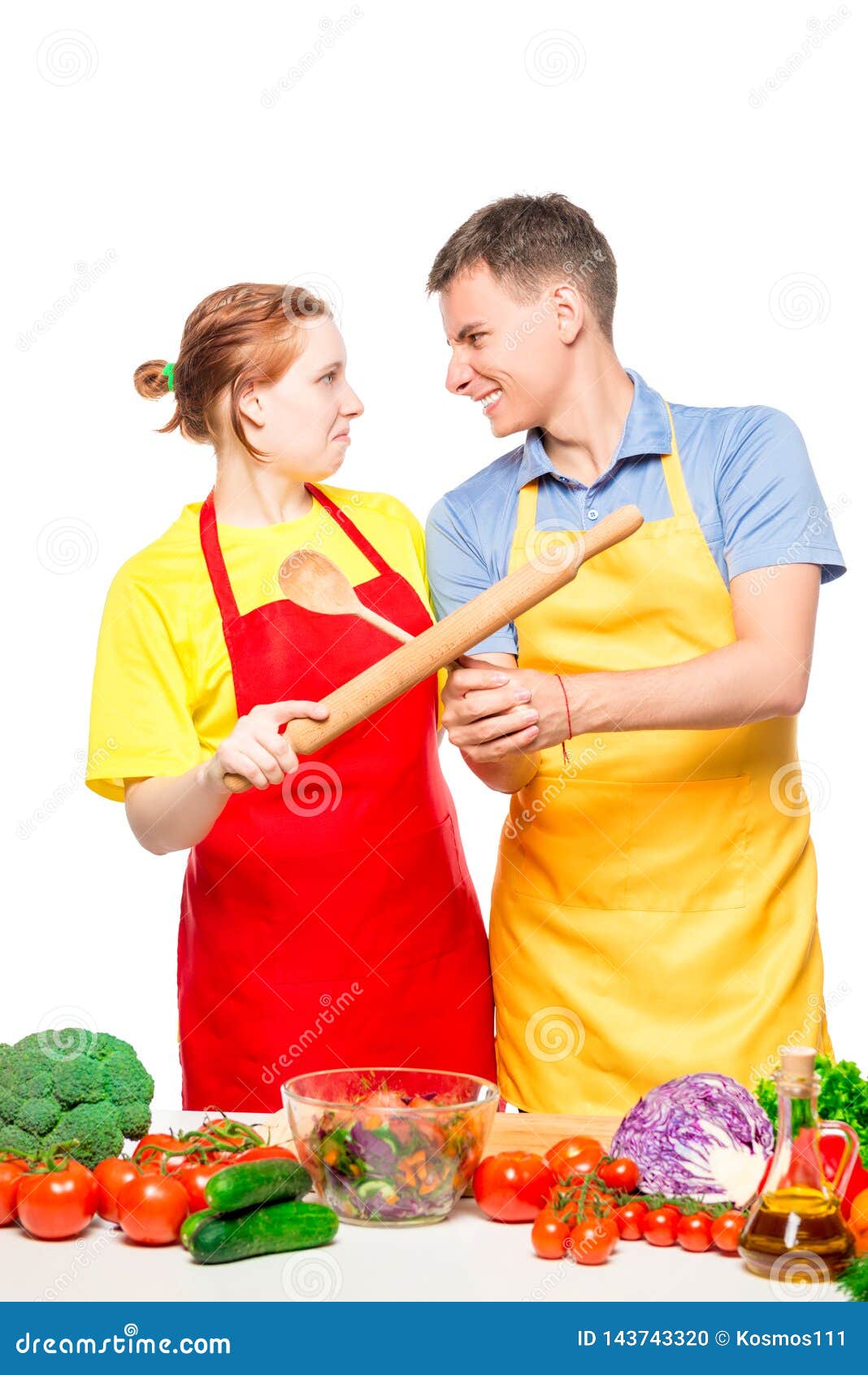 Couple Fighting with Kitchen Utensils while Cooking Salad on White ...