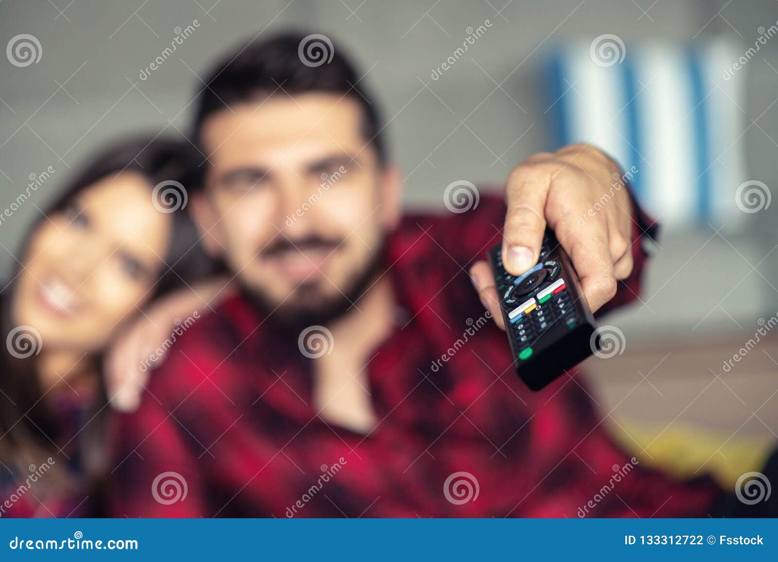 Couple Fighting for Remote Control while Watching TV at Home Stock ...