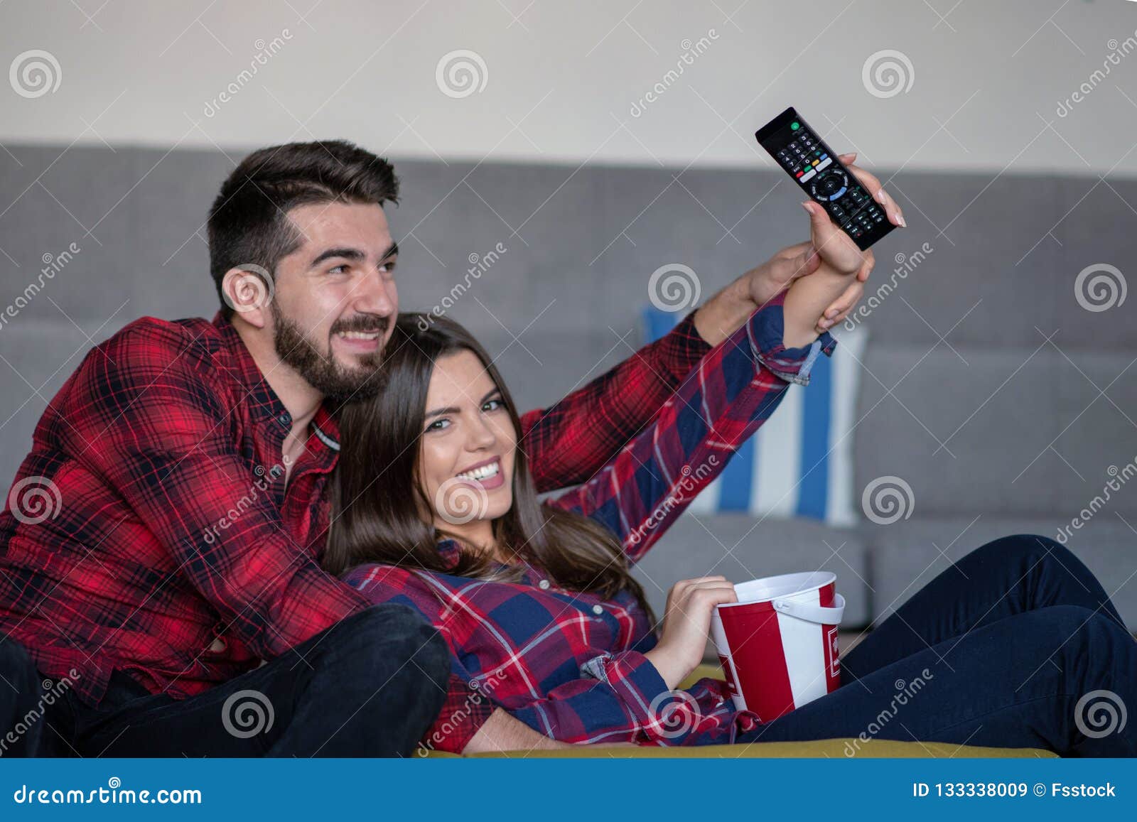 Couple Fighting for Remote Control while Watching TV at Home Stock ...
