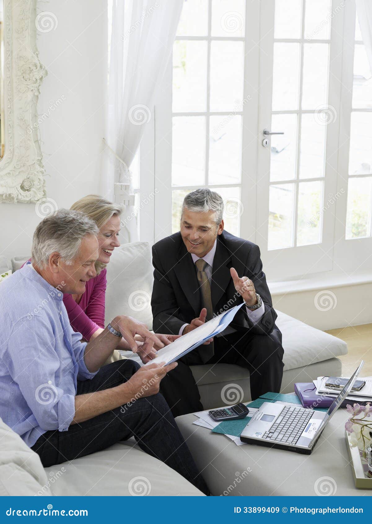 Couple with Financial Advisor at Sofa Stock Image - Image of laptop ...