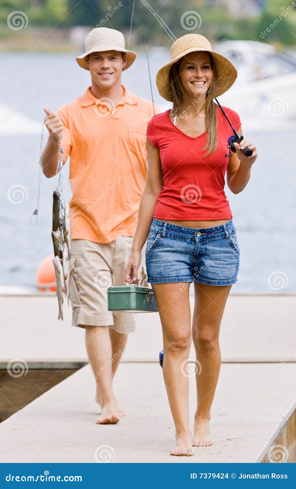 Couple fishing on pier stock photo. Image of friendship - 7379424