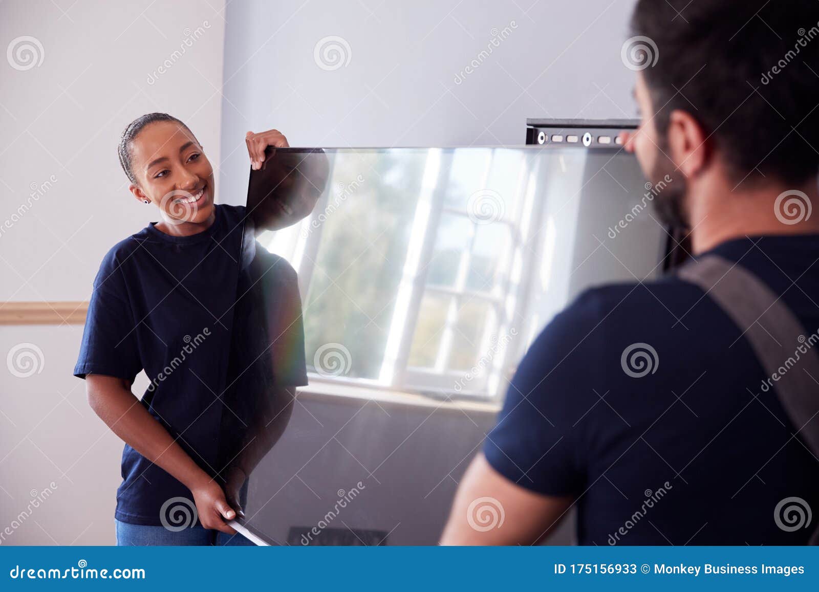 Couple Fitting Flat Screen TV Onto Wall at Home Together Stock Image ...
