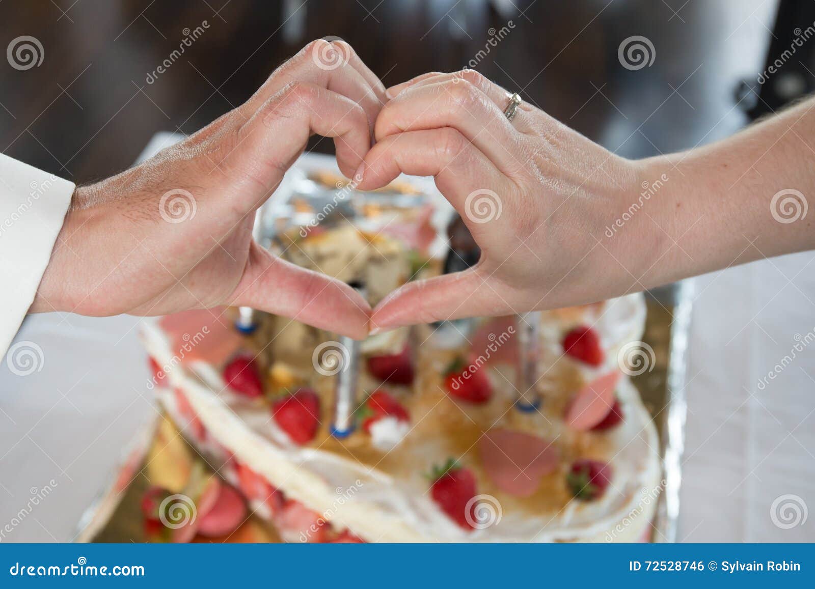 Couple in Front of Cake Making a Heart with Hands Stock Photo - Image ...